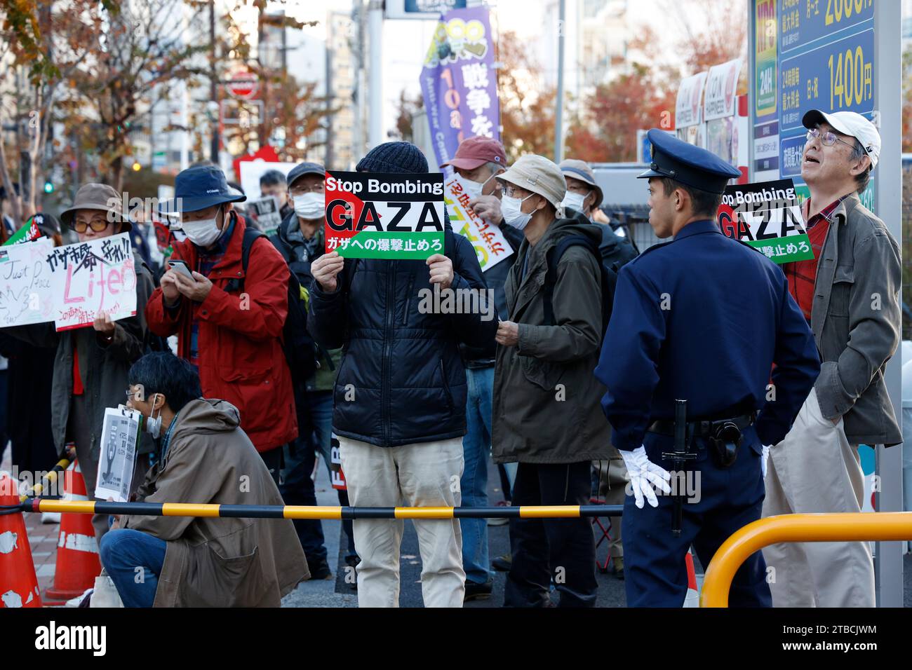 Tokyo, Japan. 6th Dec, 2023. Protestors holding placards with the ...