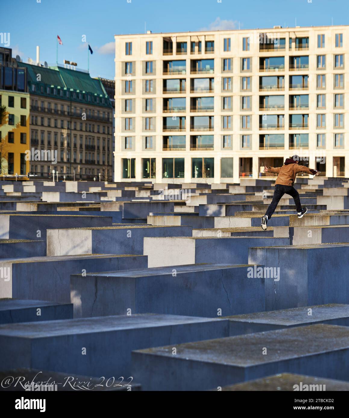 Kid jumping or leaping from one pillar to the other on Memorial to the ...