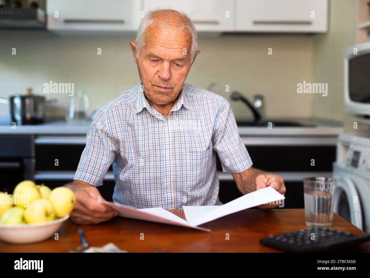 Elderly man looking utility bill hi-res stock photography and images ...