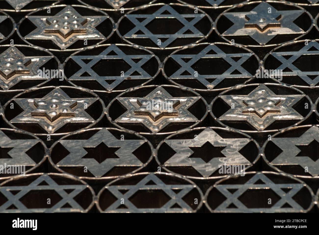 Metalwork design featuring rows of intricate silver Jewish stars of ...