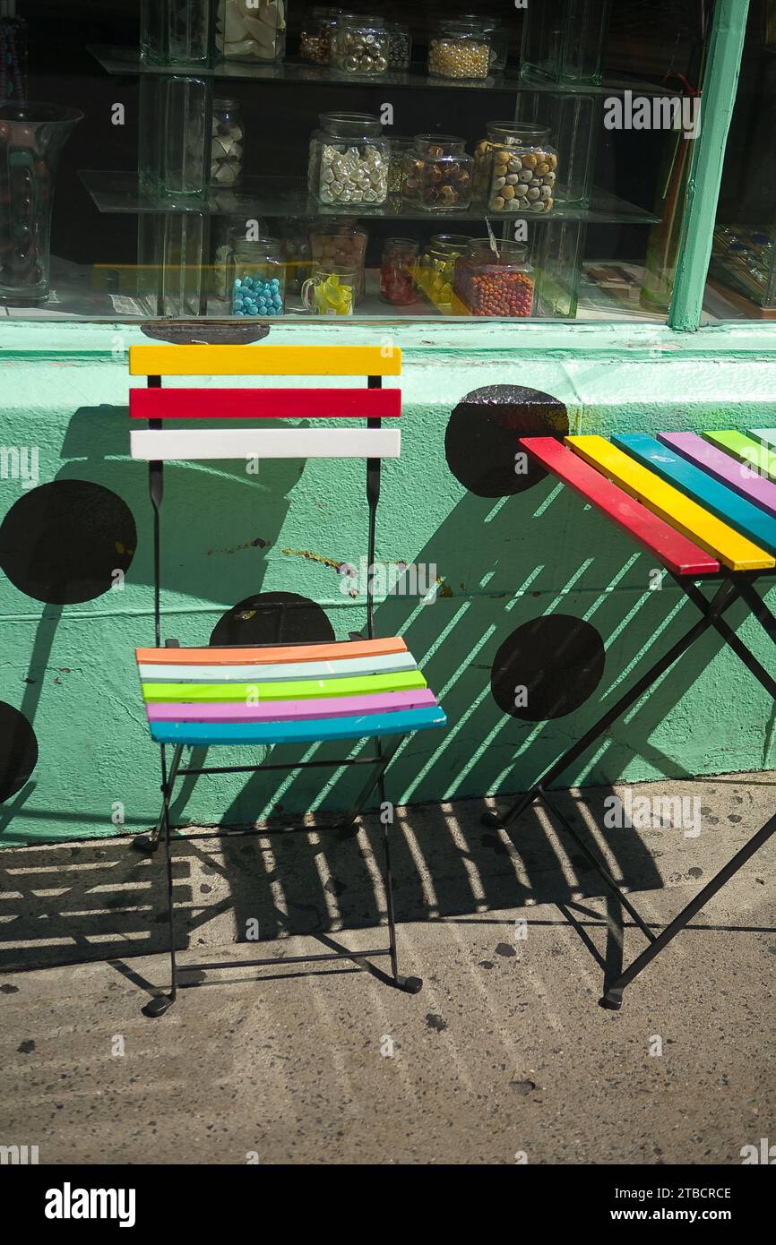 Rainbow-colored chair and table in front of a candy shop Stock Photo ...