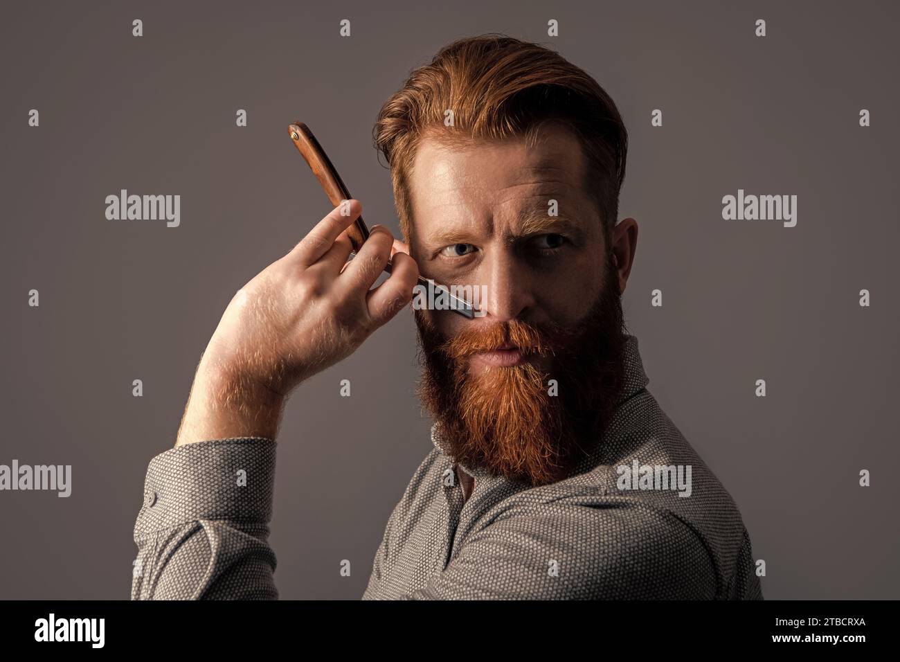 handsome hairdresser man with blade to make haircut. man in hairdresser ...
