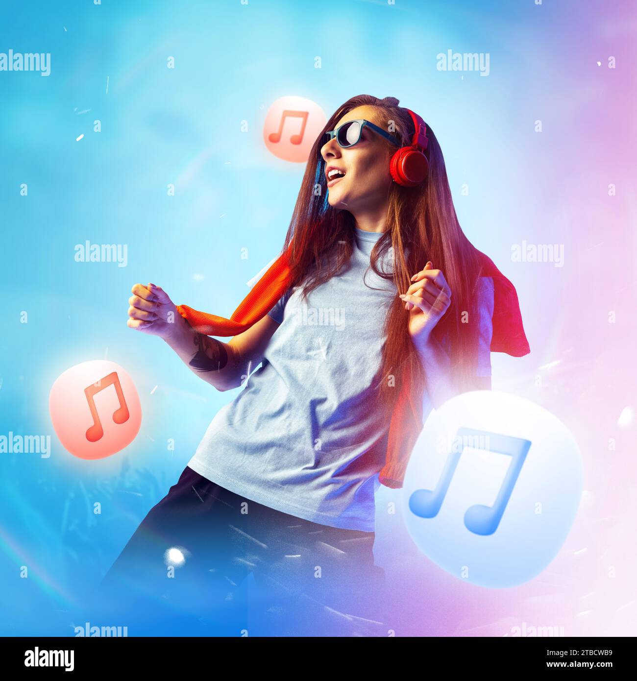 Young woman moving briskly, dancing while listening tracks from her ...