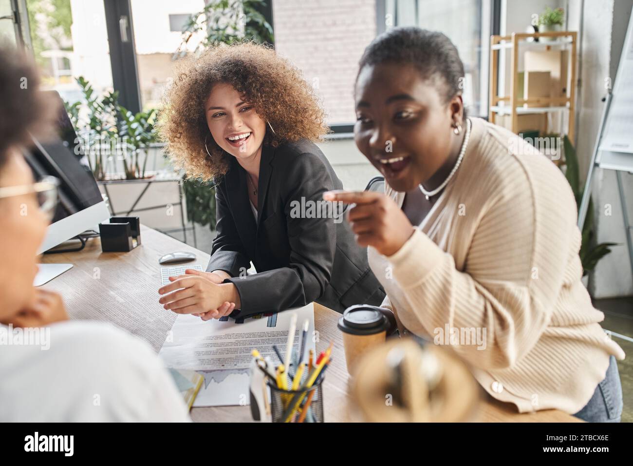 creative team of ambitious multiethnic businesswomen talking near ...