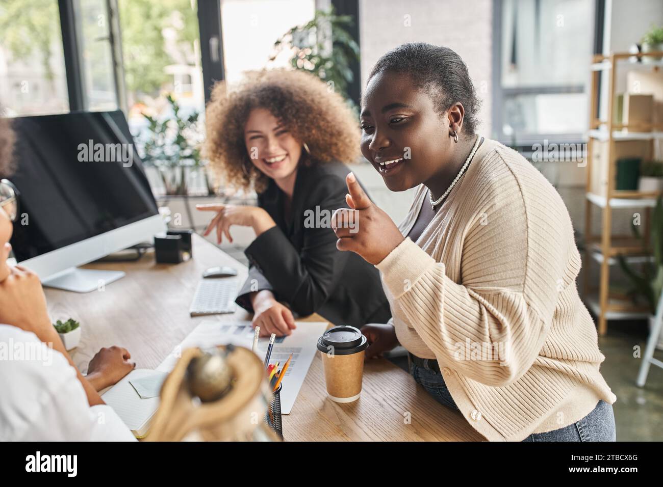 creative team of ambitious multiethnic businesswomen talking near ...