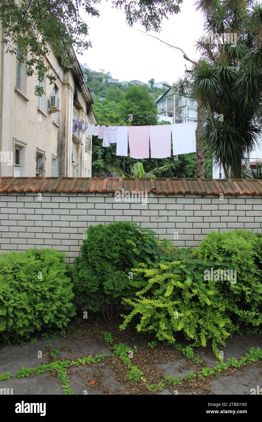 Laundry laid out to dry between houses Stock Photo - Alamy