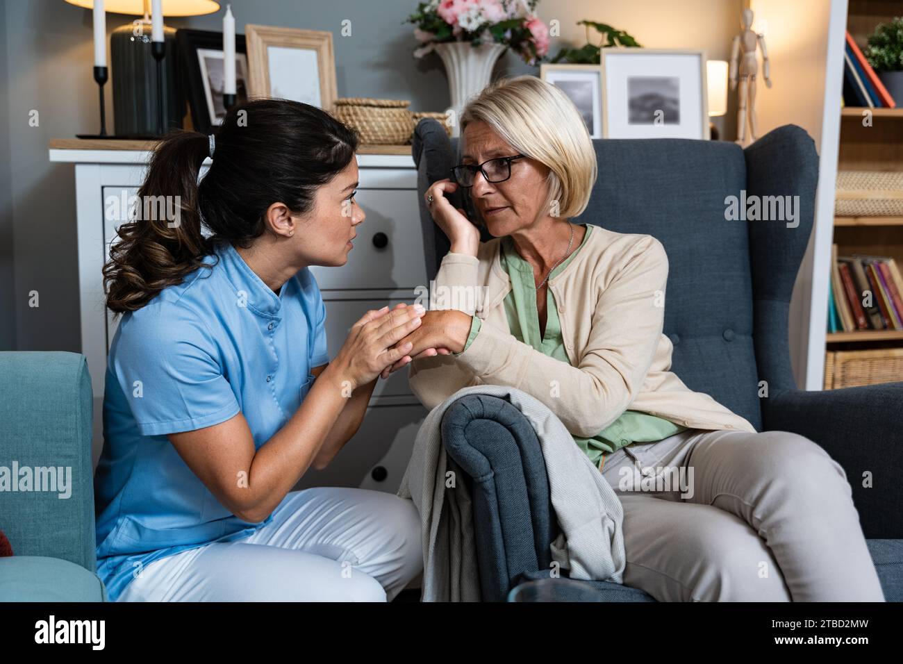 Young woman doctor health care worker medic nurse comforting older ...