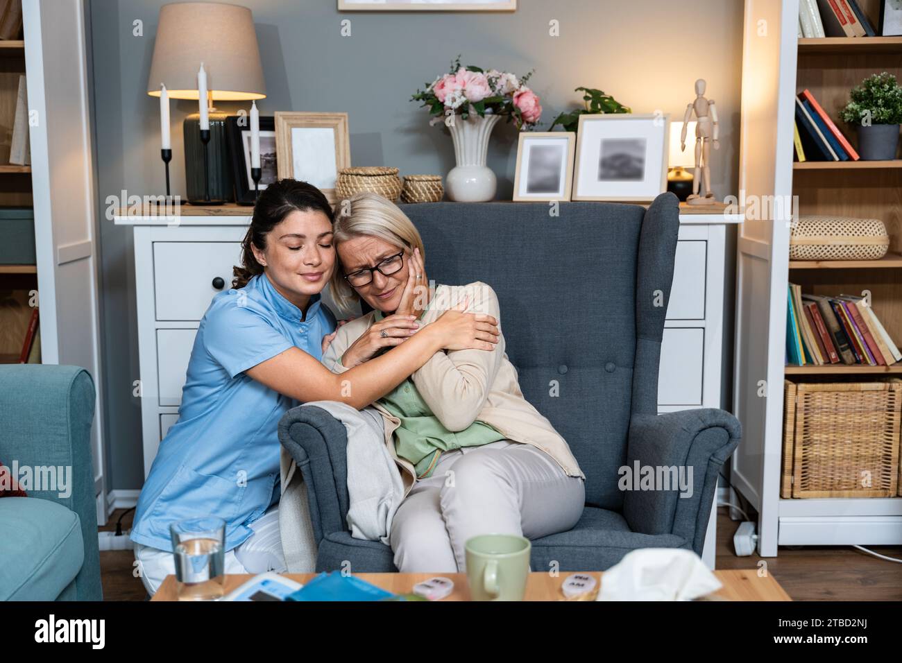 Young woman doctor health care worker medic nurse comforting older ...