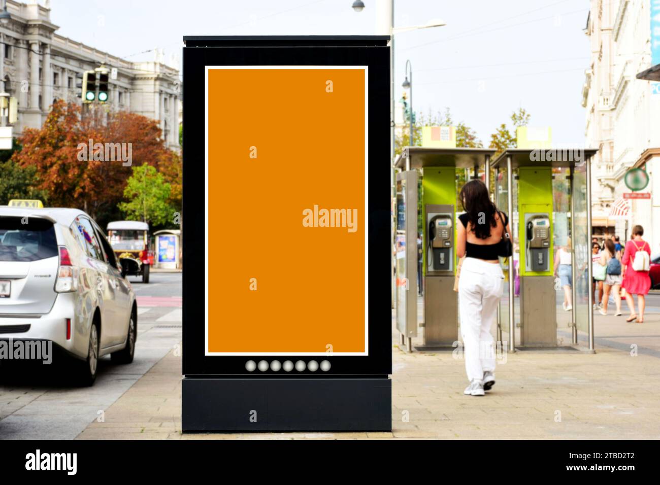 blank street ad panel and lightbox with pedestrians walking by ...