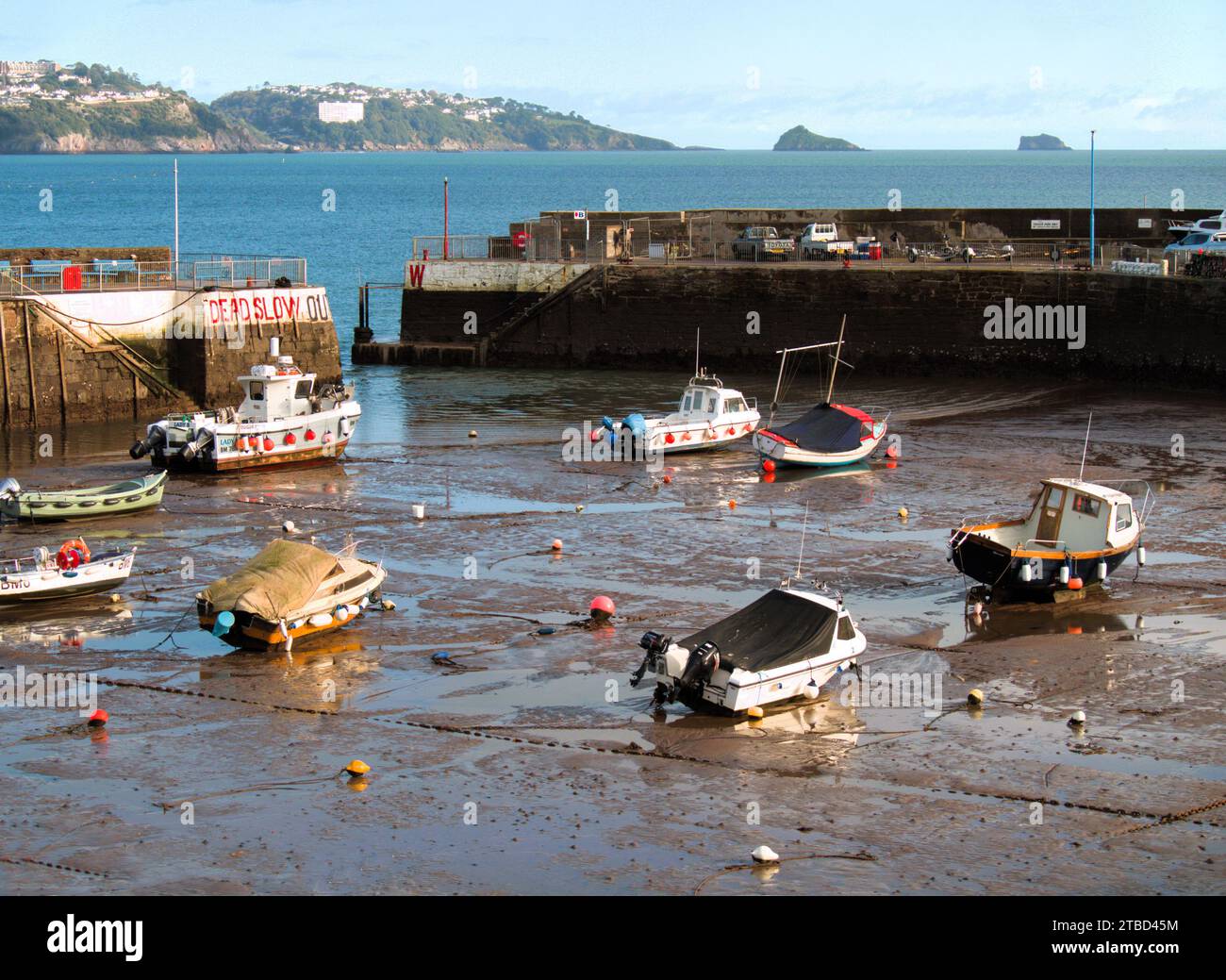 Tides out leaving boats resting on the sandy bed of Paignton harbour ...