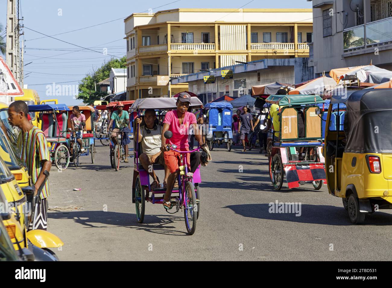 Road traffic with bicycle rickshaws, bright colours, Morandava ...