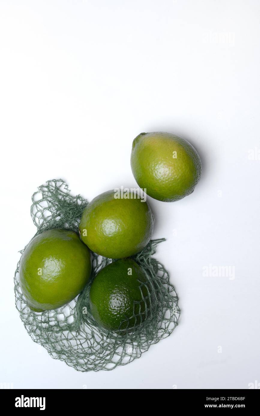 Limes with packing net, citrus fruits Stock Photo - Alamy