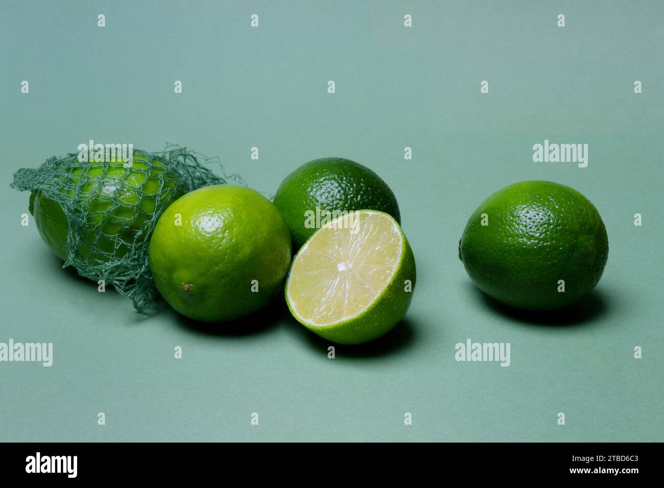 Limes with packing net, citrus fruits Stock Photo - Alamy