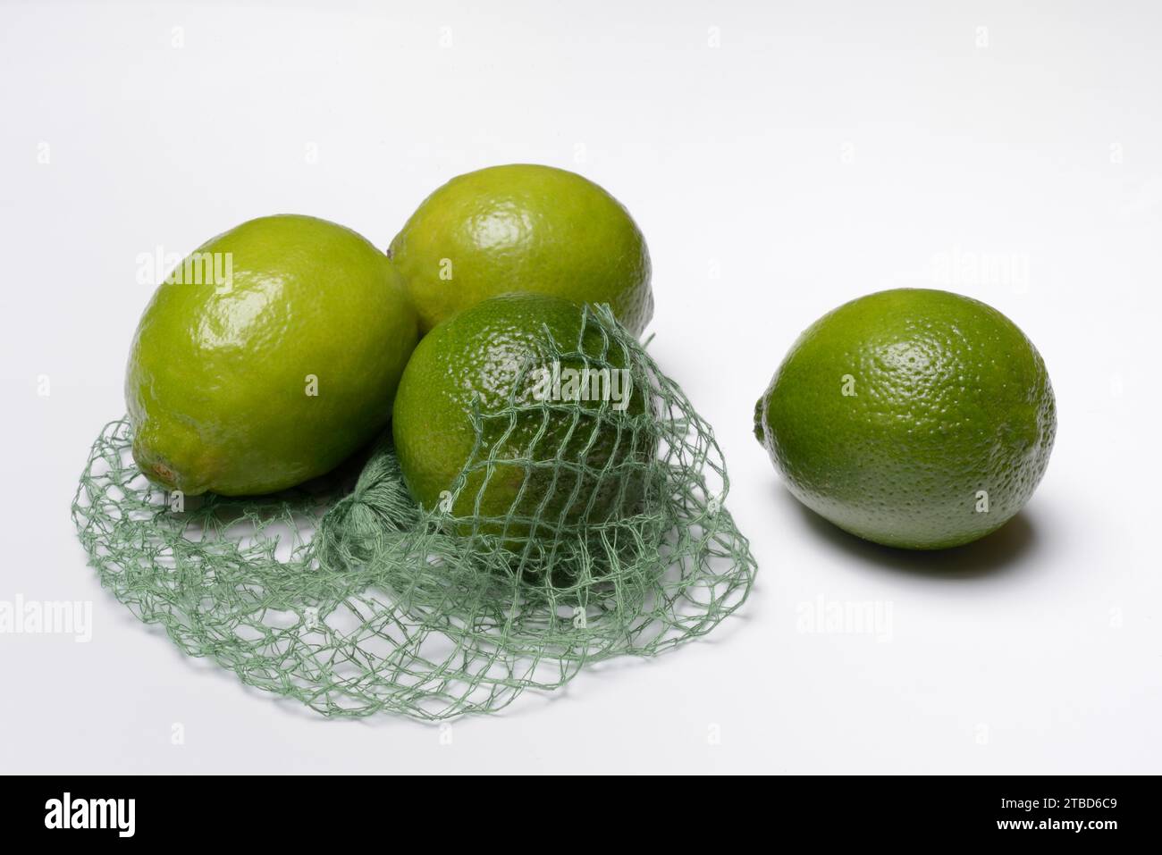 Limes with packing net, citrus fruits Stock Photo - Alamy