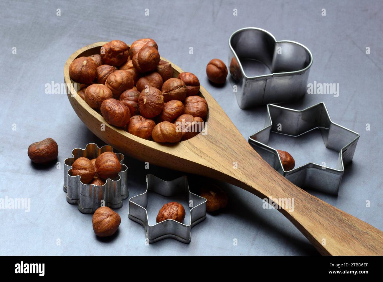 Wooden ladle with hazelnuts, cookie cutters, baking ingredient Stock ...