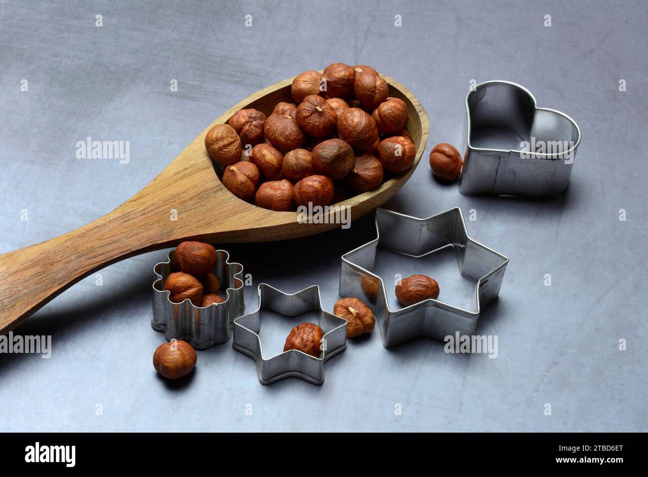 Wooden ladle with hazelnuts, cookie cutters, baking ingredient Stock ...