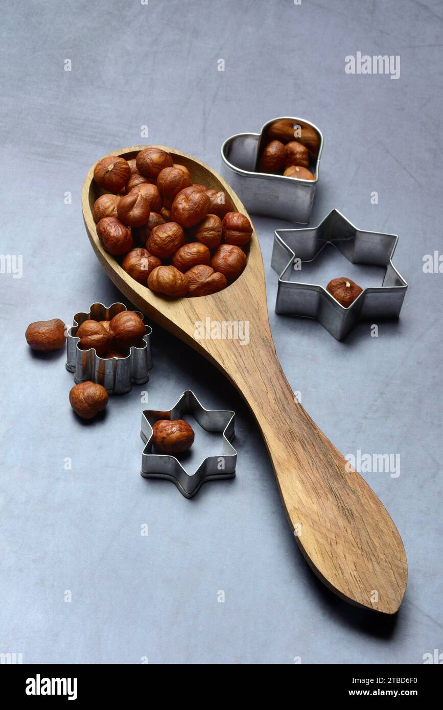 Wooden ladle with hazelnuts, cookie cutters, baking ingredient Stock ...