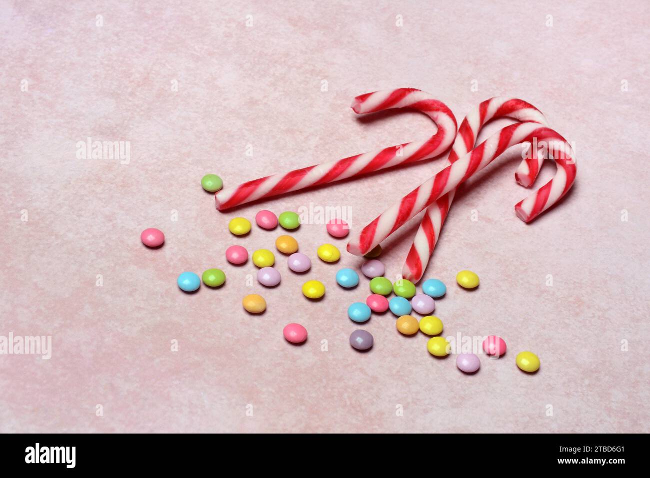 Candy canes and chocolate lentils Stock Photo - Alamy