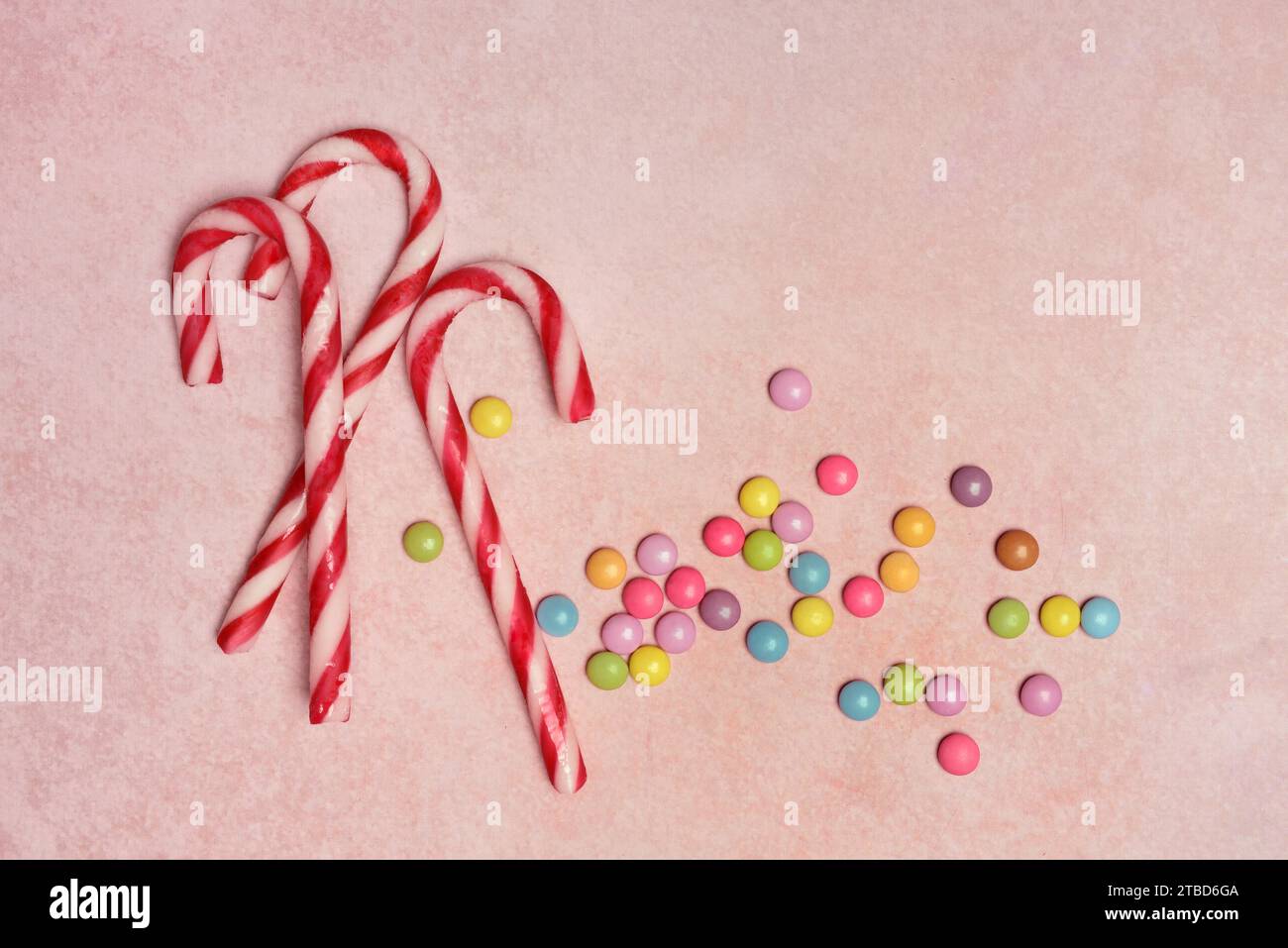 Candy canes and chocolate lentils Stock Photo - Alamy