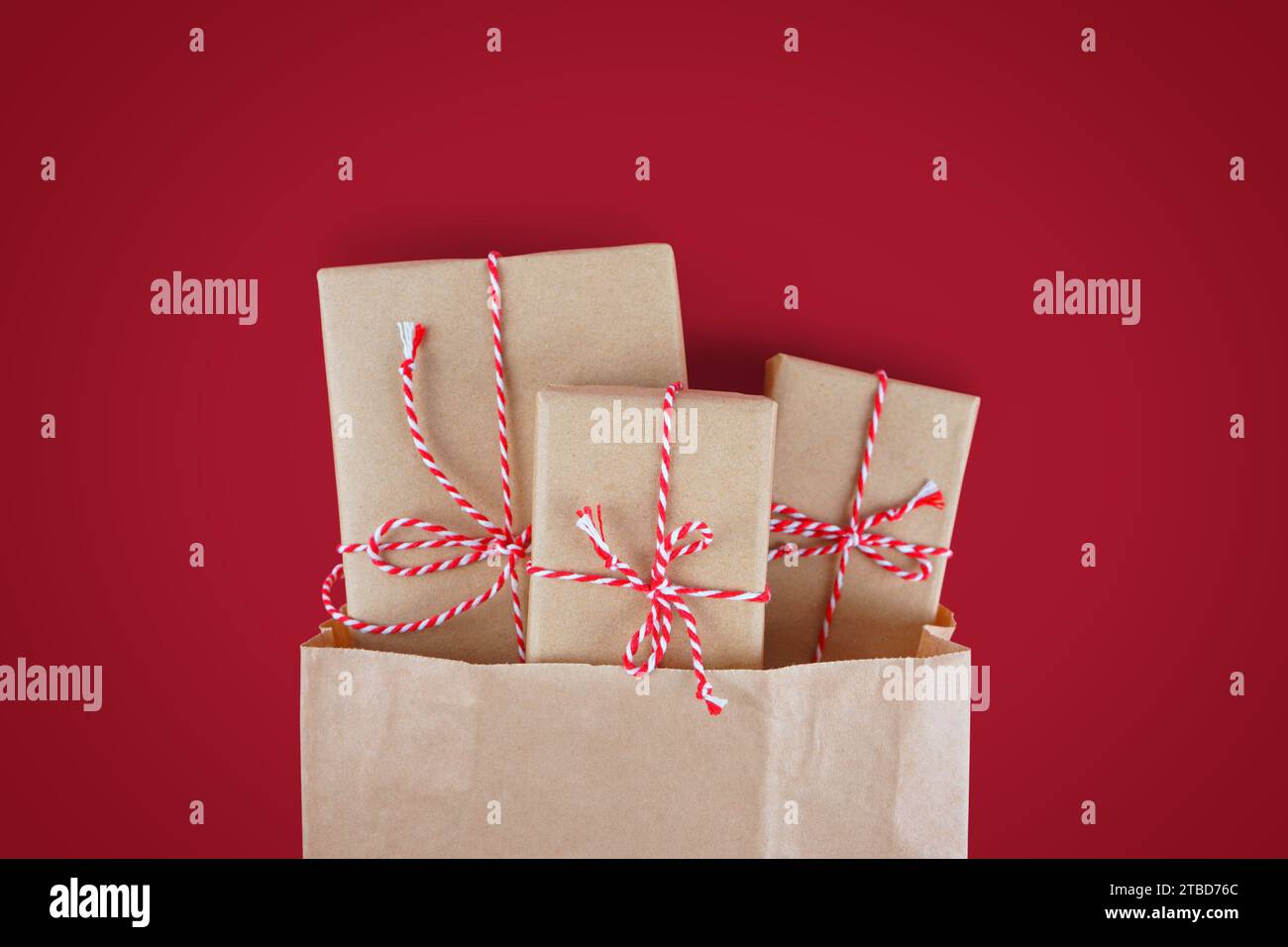 Christmas gift boxes wrapped in craft paper with striped red and white ...