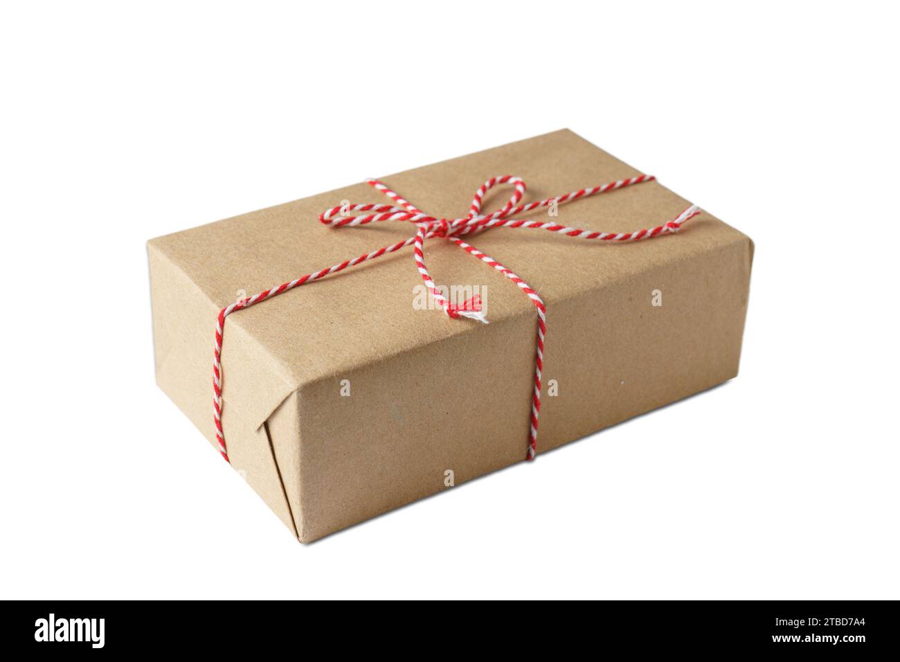 Christmas and New Year gift box wrapped in brown craft kraft paper with red and white baker's ...