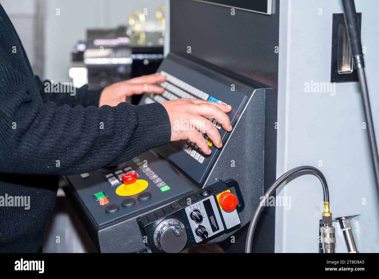 Close-up of the hands of an industrial male manual worker operating ...