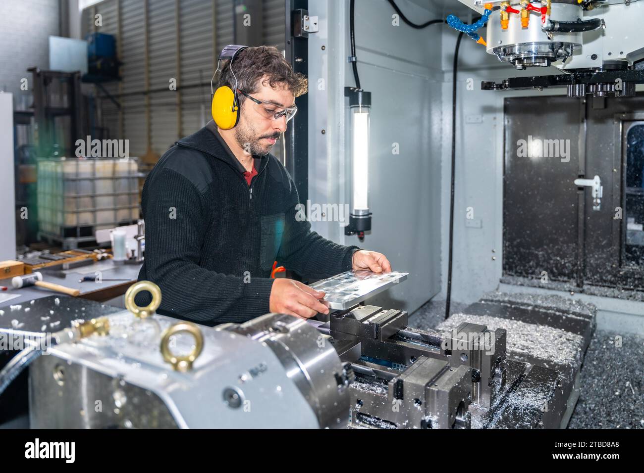 Engineer working with a milling cnc machine using safety gear Stock ...