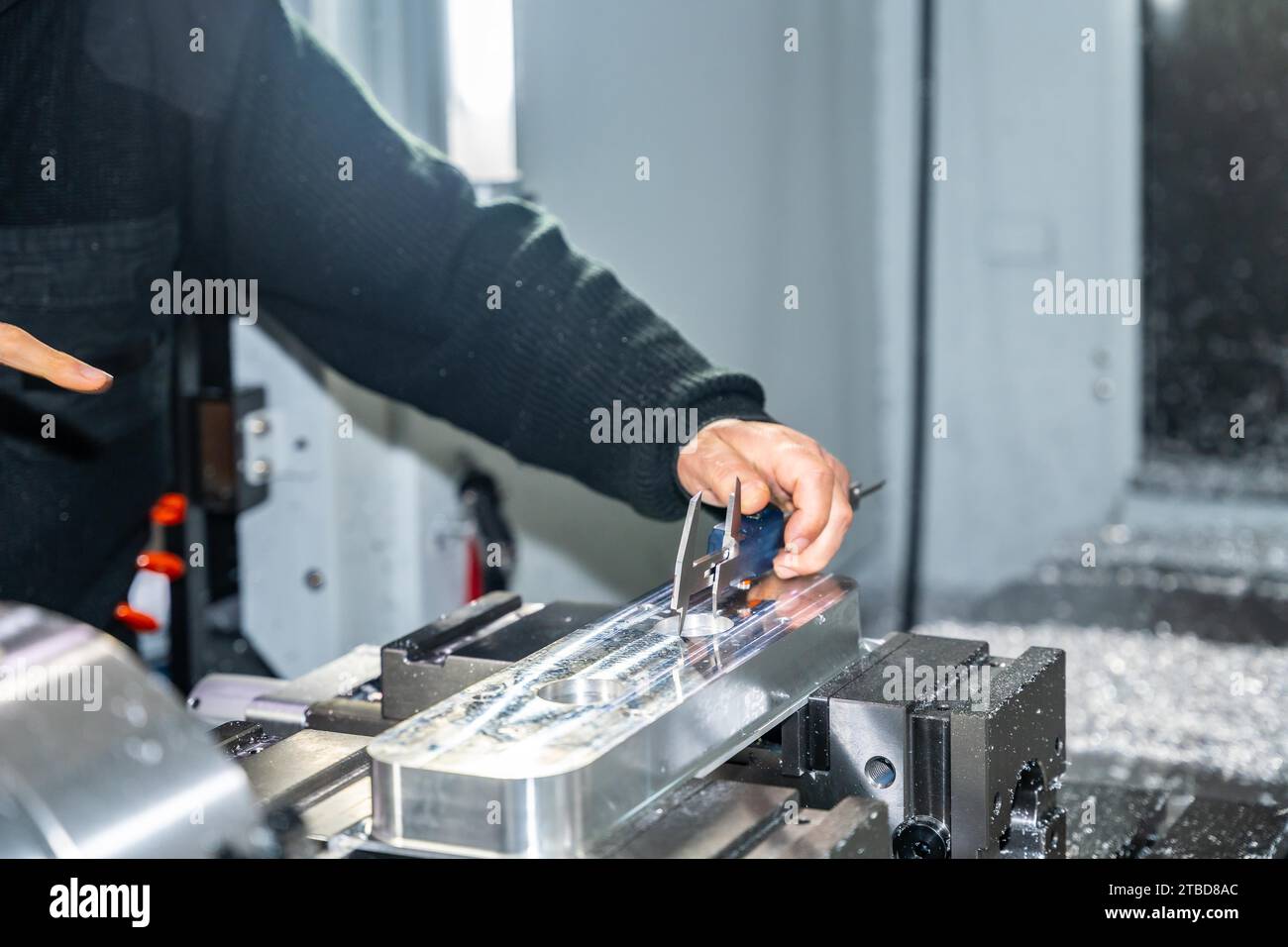 The expert engineer using caliper in workshop to measure dimension of ...