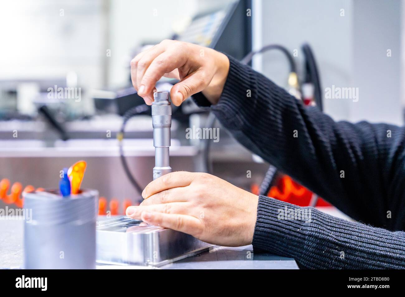 Close-up of an unrecognizable manual worker using tool to fix a metal ...