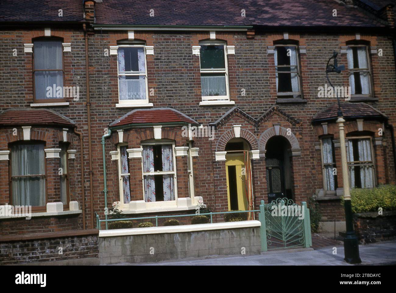 1970s, historical, victorian terrace houses, one with a modern yellow ...