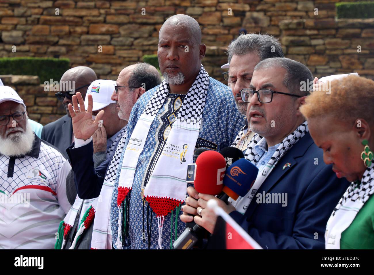 Hamas official Basem Naim, second right, speaks to journalist as Nelson ...