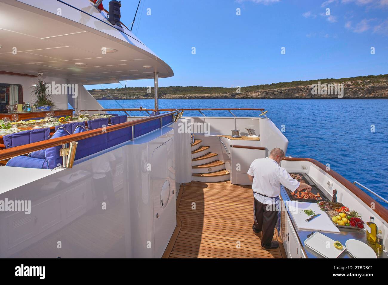 Yacht chef preparing quality food for charter guests on the deck ...