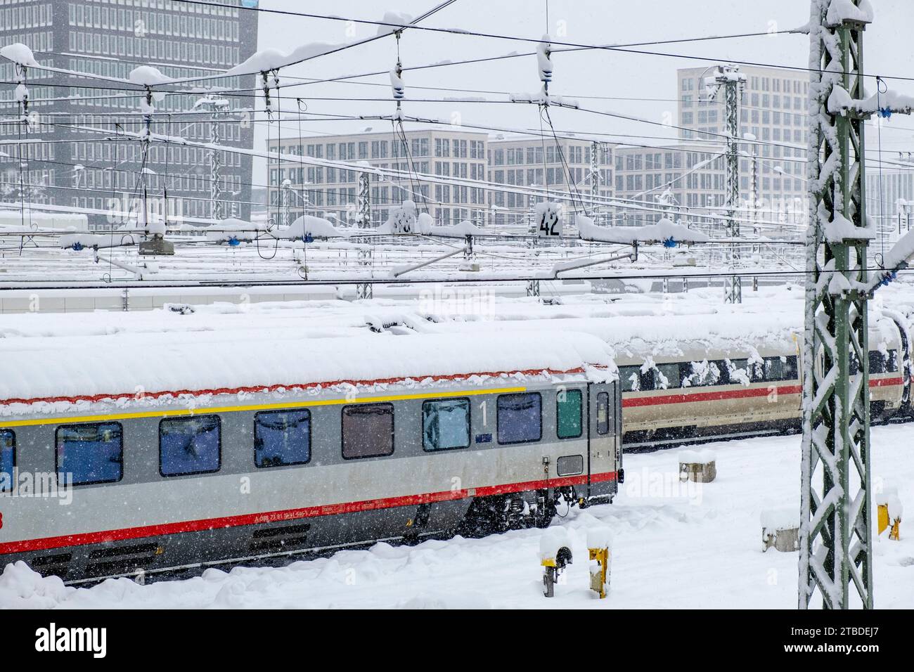 Stationary trains after heavy snowfall in front of the main railway ...