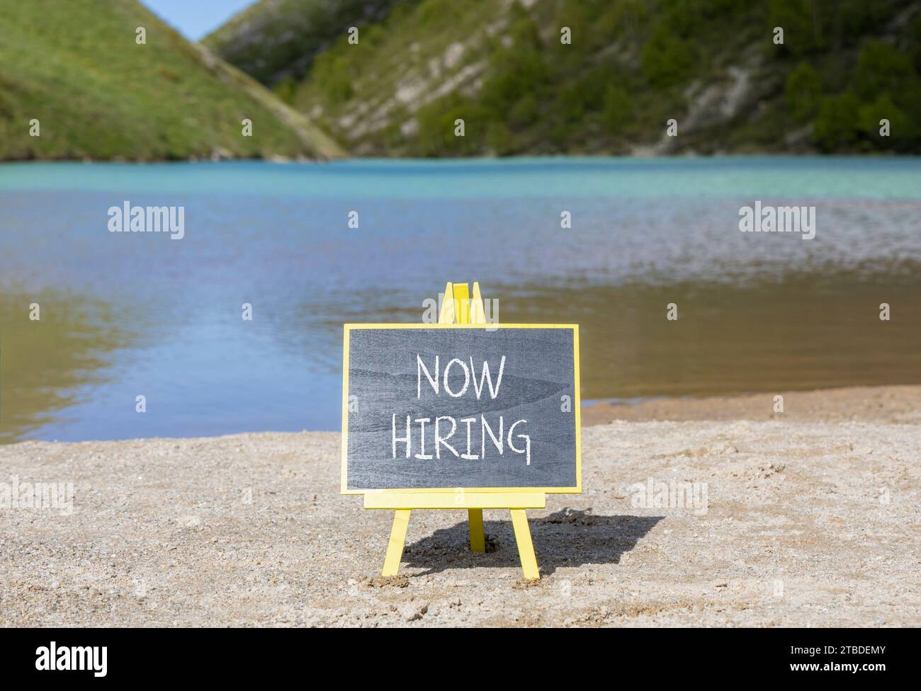 Now hiring symbol. Concept words Now hiring on beautiful black chalk ...