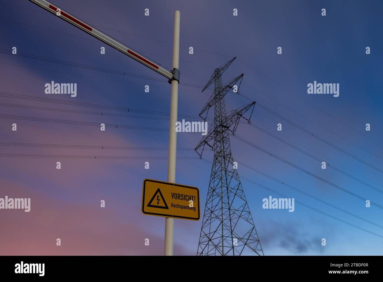 Caution sign! High voltage, power pylon behind, Wolmirstedt, Saxony ...