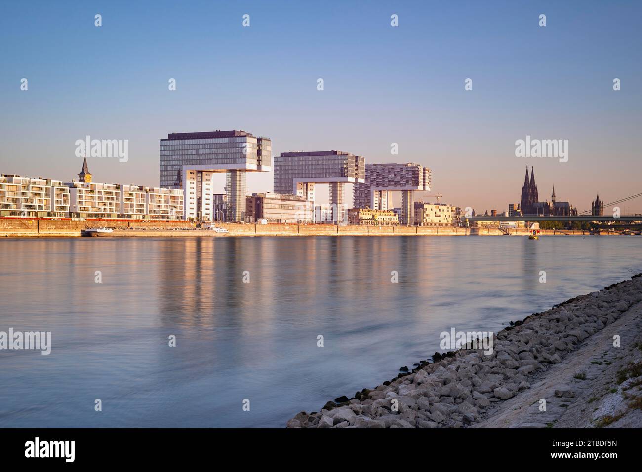 Crane houses in the Rheinau harbour and Cologne Cathedral seen across ...