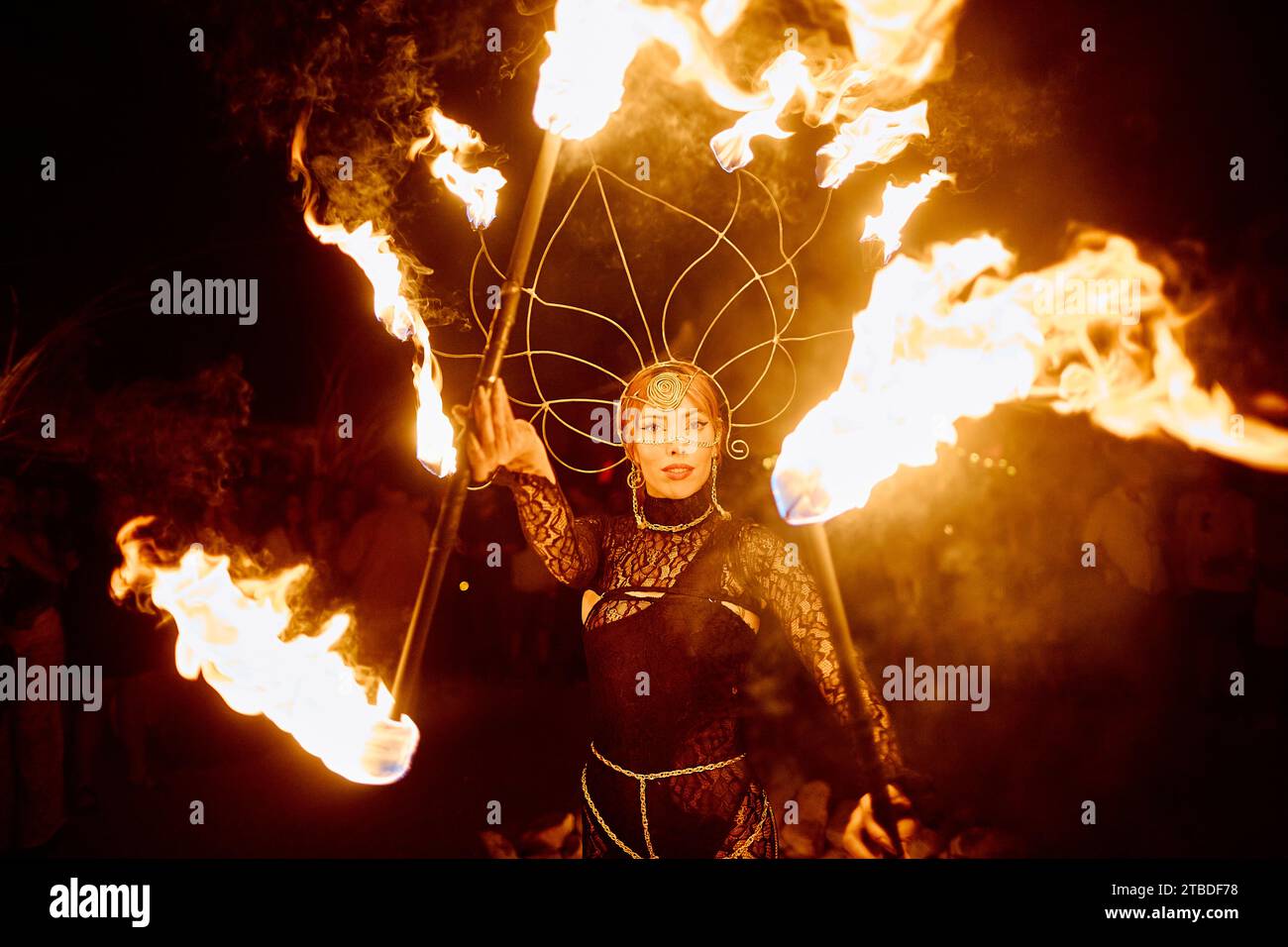 Artists perform a fire performance, under the dark night and before an ...