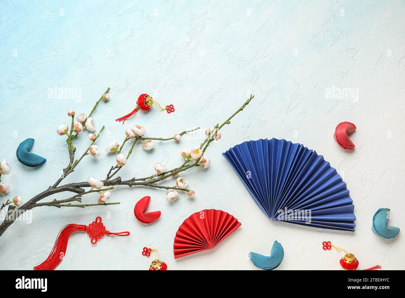 Composition with blooming sakura branch, tasty fortune cookies and ...