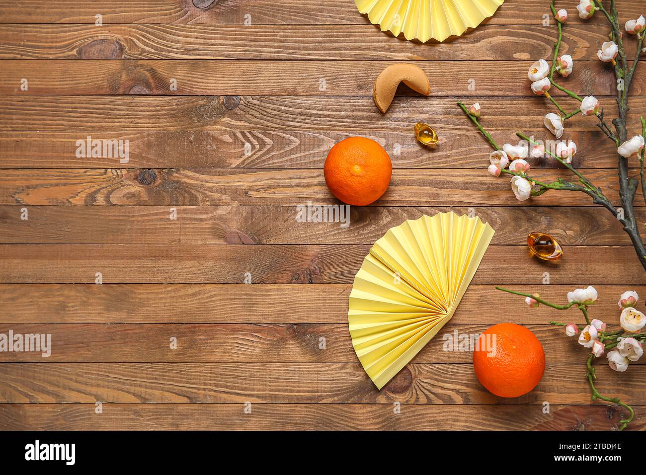 Composition with blooming sakura branch, Chinese symbols and tangerines ...