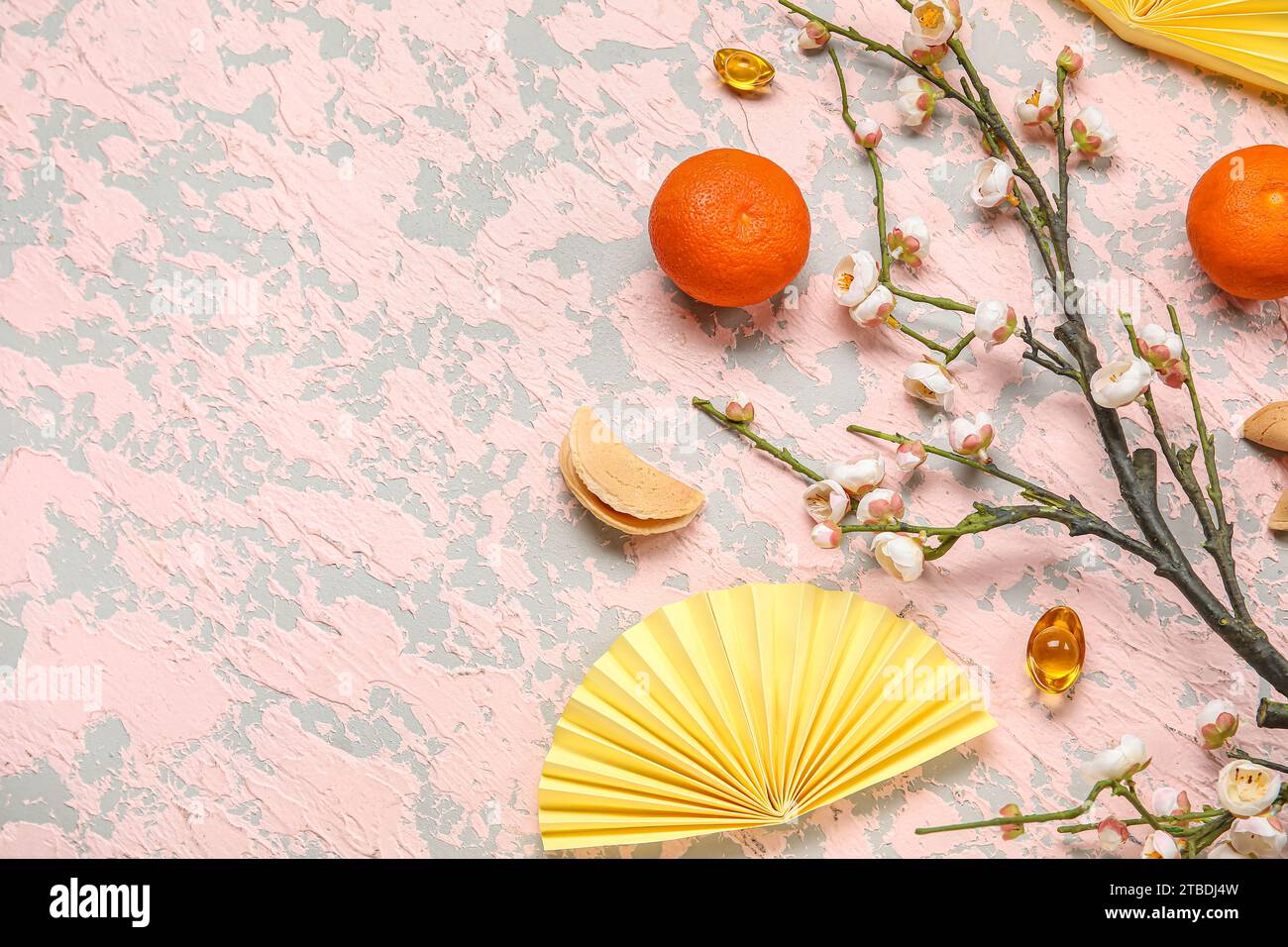 Composition with blooming sakura branch, Chinese symbols and tangerines ...