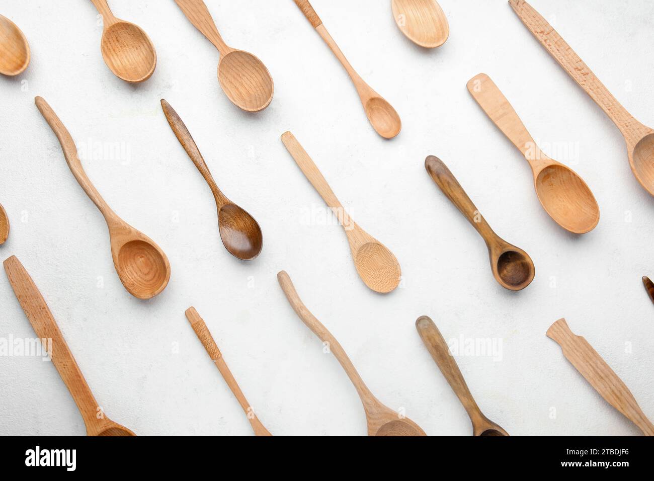 Different stylish wooden spoons on light background Stock Photo - Alamy