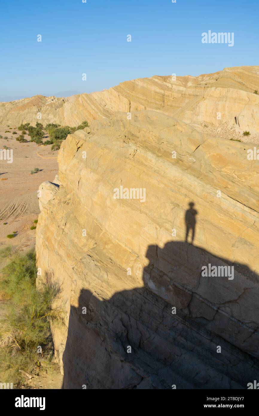 Silhouette of a person cast on a rock face in Box Canyon Wash in Mojave ...