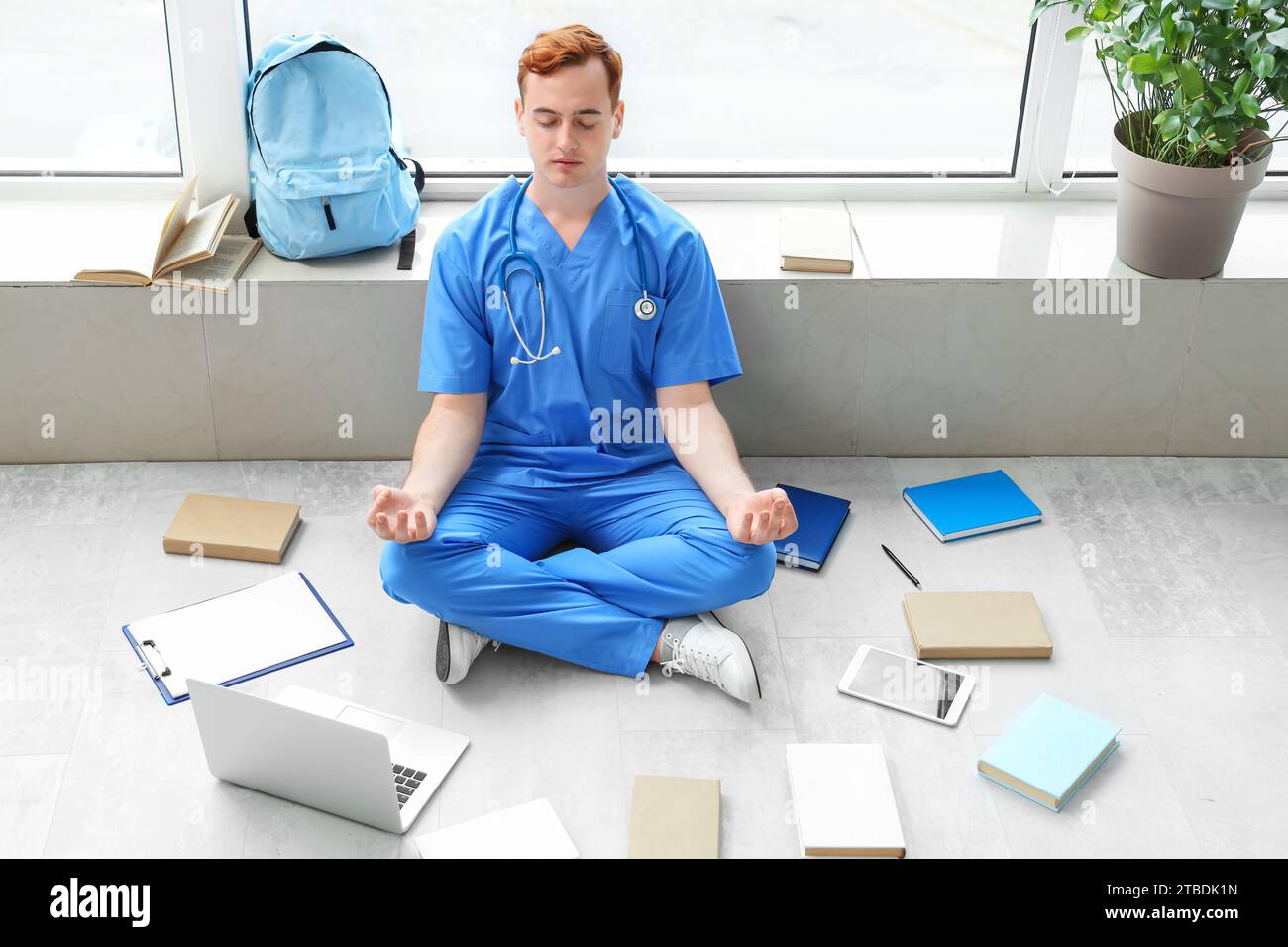 Male medical student meditating at university Stock Photo - Alamy