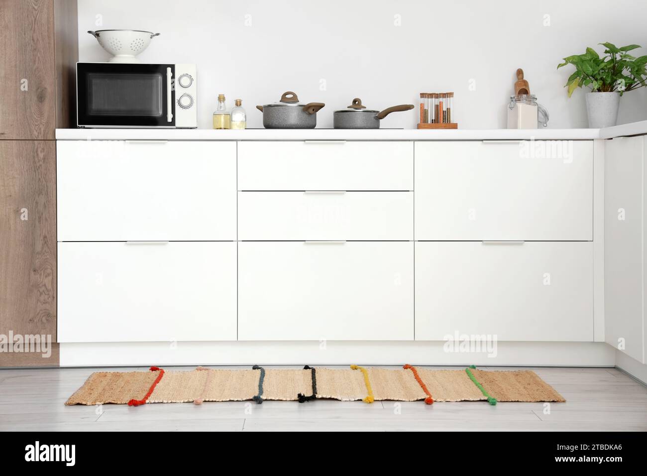 Interior of light kitchen with counters and carpet Stock Photo - Alamy