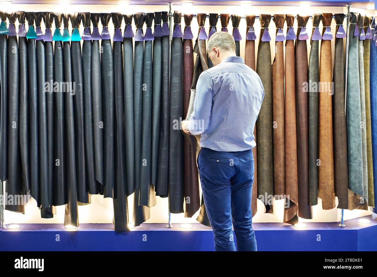 Man chooses leather in a store Stock Photo - Alamy