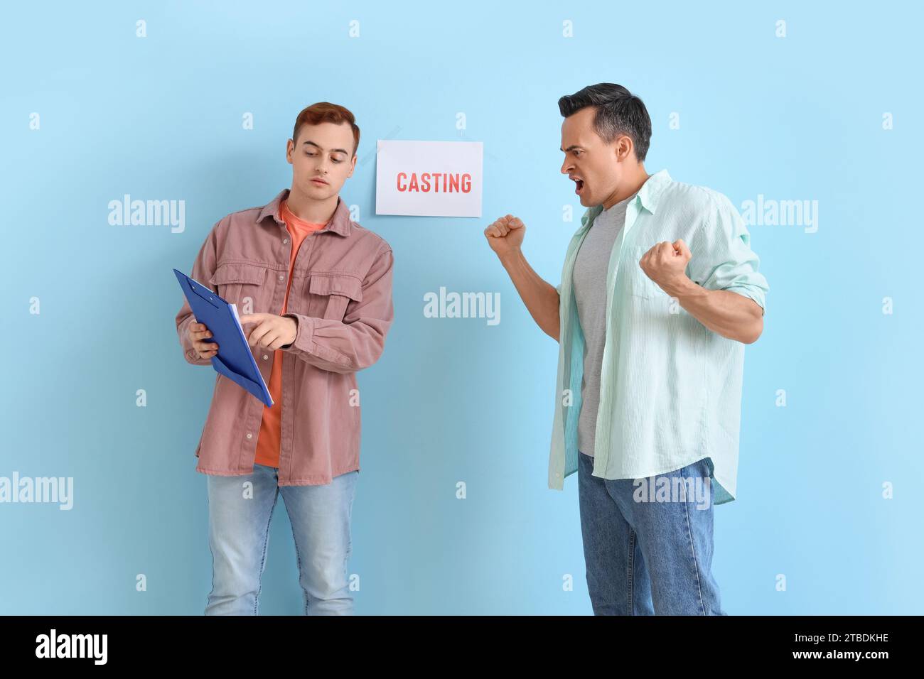 Male actors casting near blue wall Stock Photo - Alamy