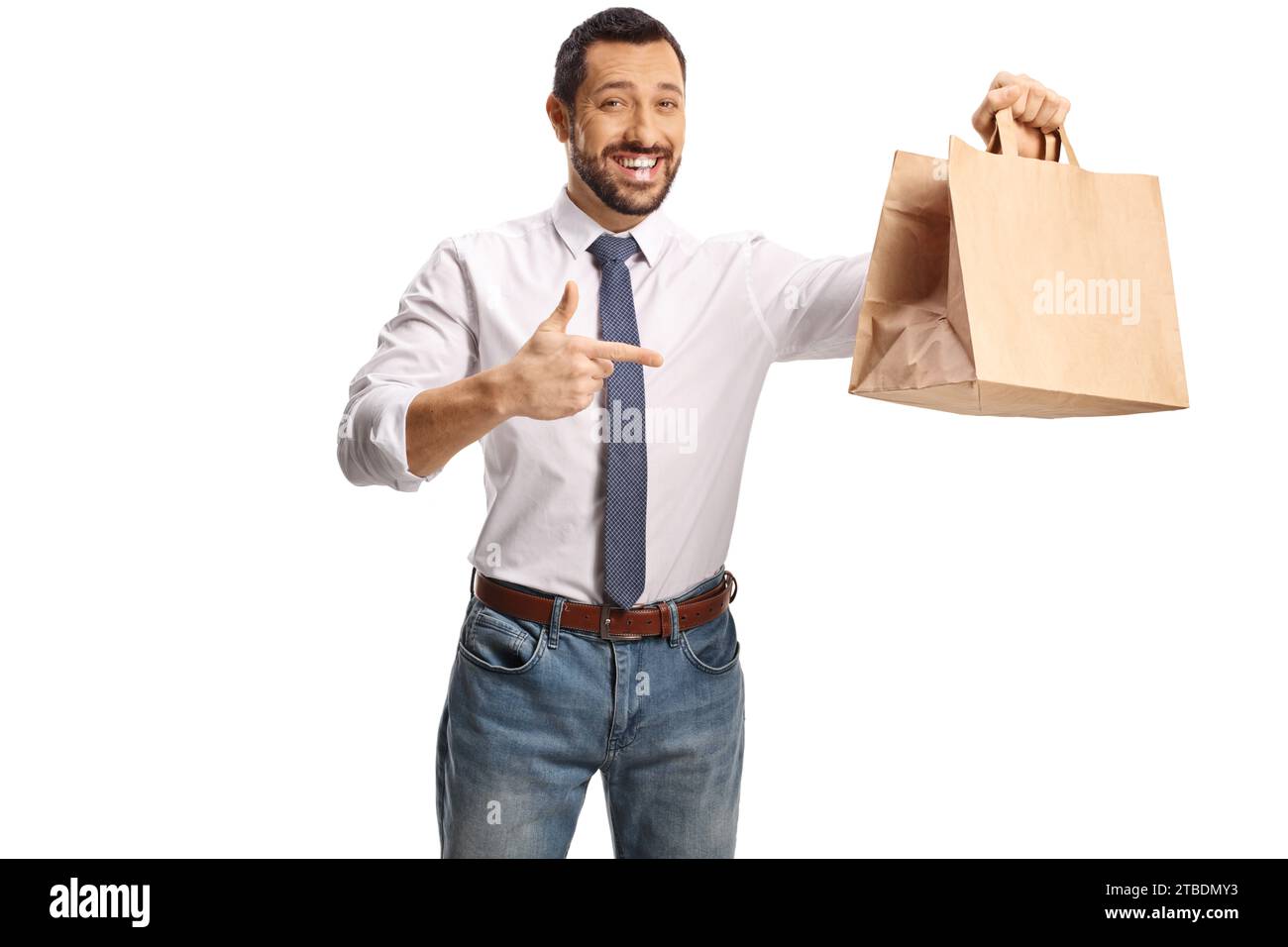 Man pointing at a paper bag and smiling isolated on white background ...