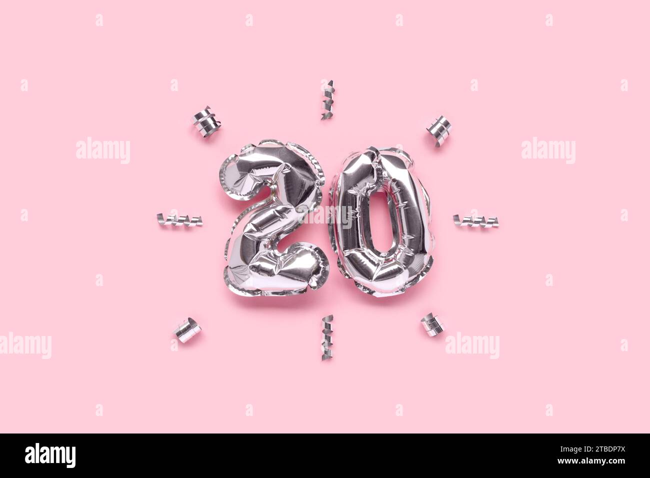 Number twenty silver air balloons with ribbons confetti on a pink ...
