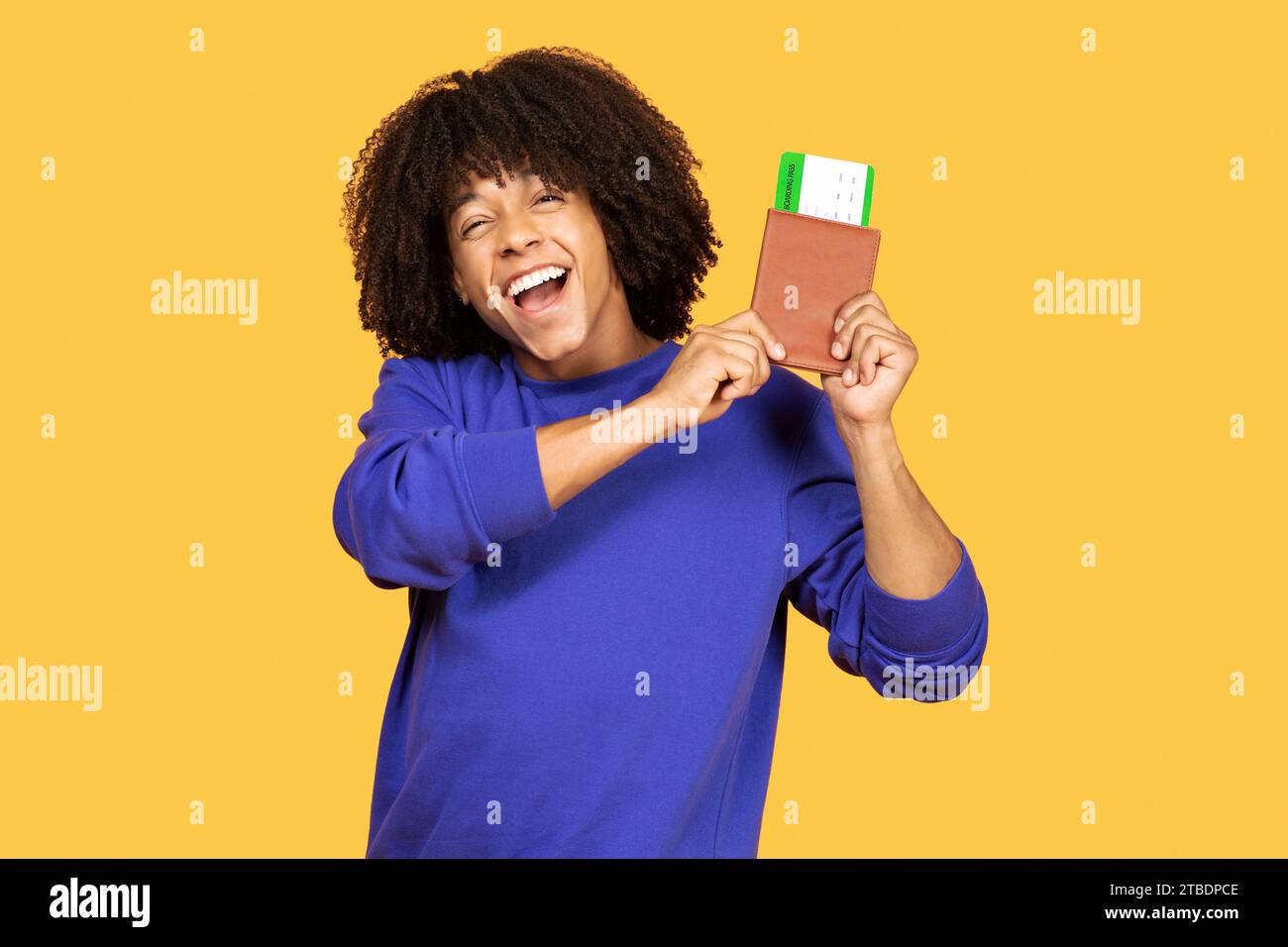 Joyful young black man holding passport and boarding passes Stock Photo ...