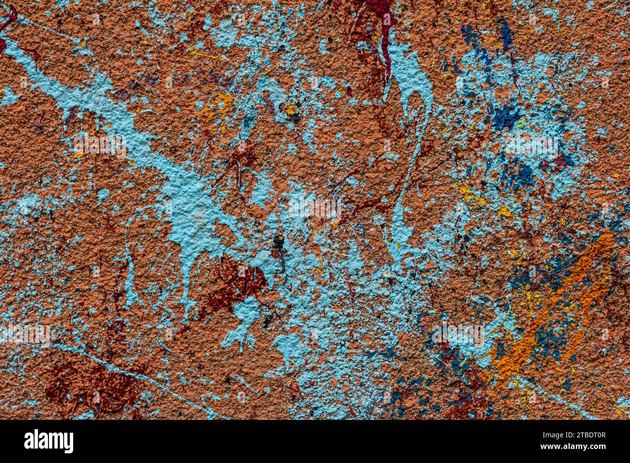 White plastered wall splattered with red paint. Paint splashes on the ...